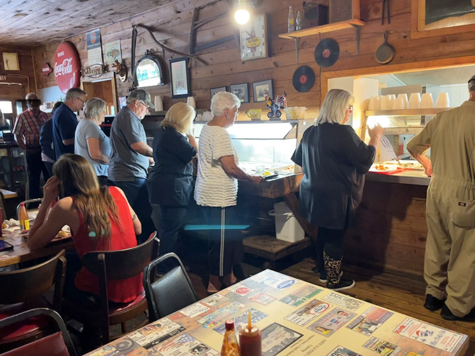 The buffet pilgrimage in progress – locals lining up for their turn at the altar of comfort food, where patience is always rewarded.