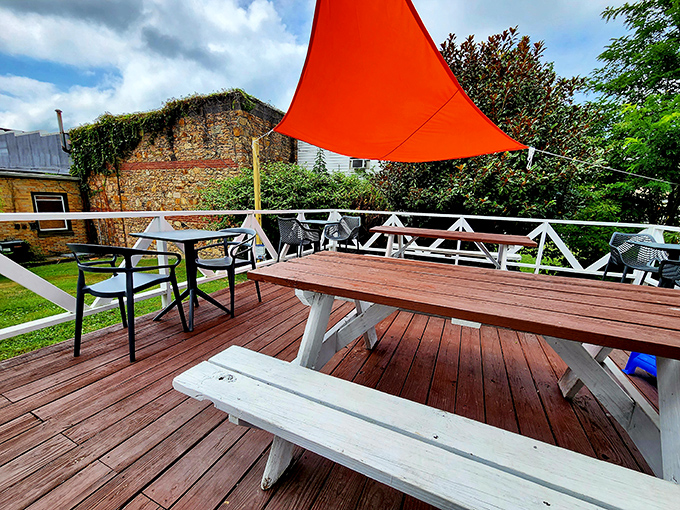 The outdoor dining deck—where fresh air makes everything taste better. That orange canopy provides just enough shade to keep your breakfast experience perfect.