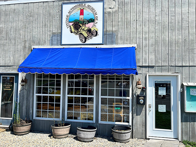 Summer brings a bright blue awning to welcome visitors, like a friendly wink from a building that knows exactly what treasures it's hiding inside.