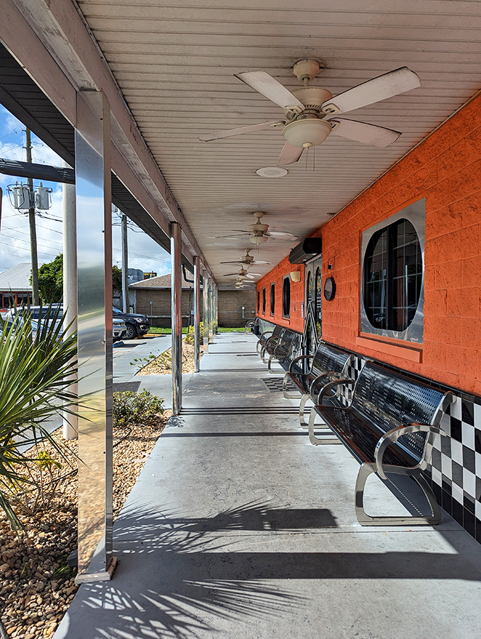 The covered walkway isn't just practical—it's where anticipation builds as you approach those checkered walls, knowing comfort food awaits just beyond the door.
