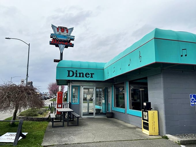 That turquoise-trimmed diner with the classic car sign isn't just eye-catching – it's a time machine disguised as a restaurant.