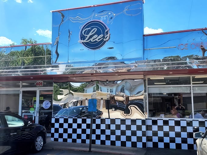 Lee's shiny chrome exterior gleams like a time machine to the 1950s, complete with that iconic checkered trim that screams "good burgers happen here!"