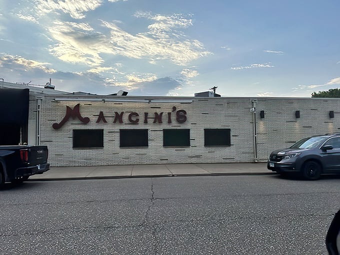 The iconic white brick exterior of Mancini's stands like a time capsule of flavor, promising char-grilled perfection within.