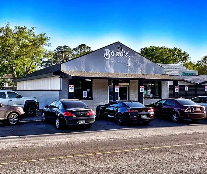 The simple storefront of Bozo's with parked cars out front tells you everything you need to know—locals crowd here for a reason.