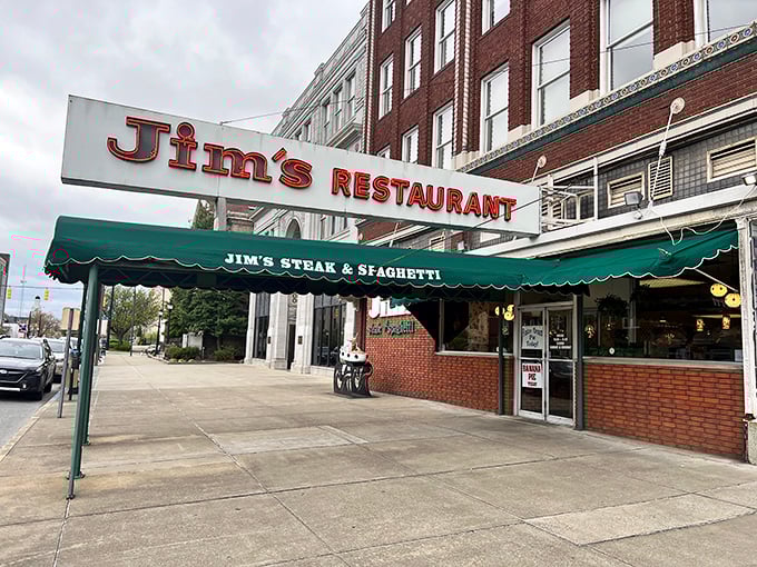 The classic green awning of Jim's Steak & Spaghetti House – where time stands still but the steaks keep coming.