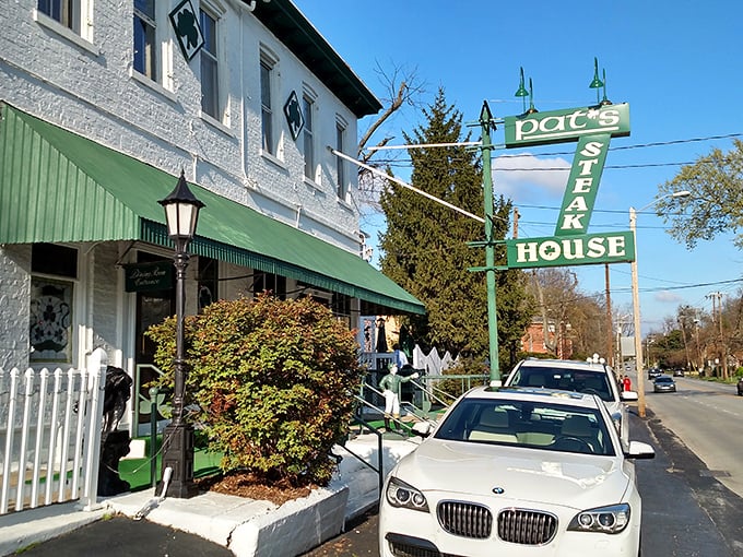 The iconic Pat's Steakhouse sign promises what lies within – a Louisville legend where steaks sizzle and memories are made.