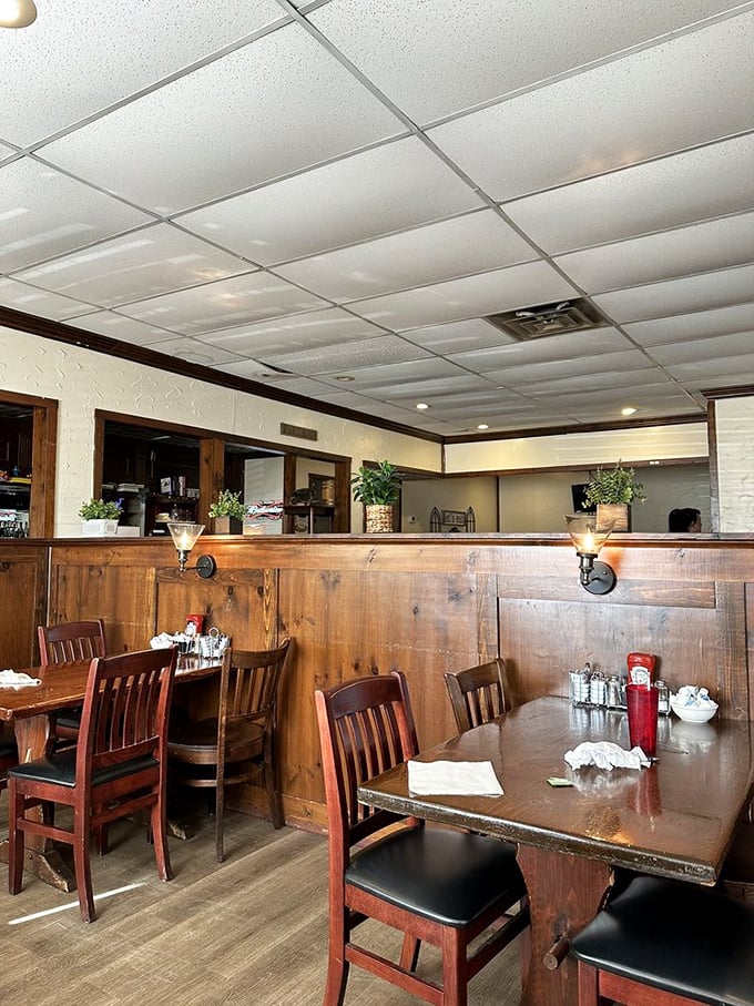 Warm wooden paneling wraps the dining room like a cozy sweater, creating the perfect backdrop for conversations that flow as easily as the coffee.