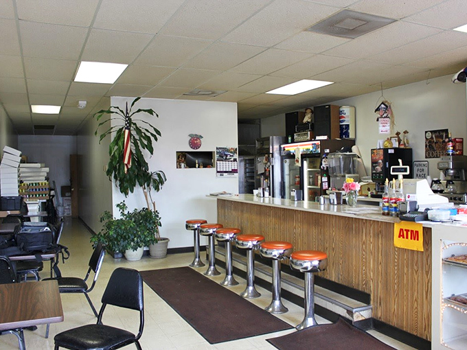 Classic counter seating with orange-topped stools—where donut dreams come true without a hint of pretension or avocado toast in sight.