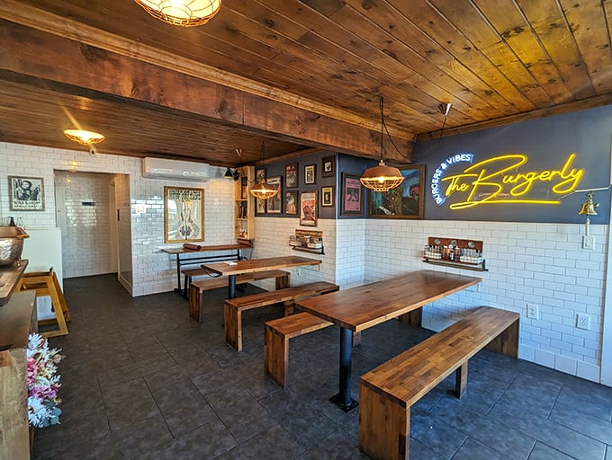 Rustic wooden tables and benches invite communal dining under warm pendant lights—burger paradise with a side of conversation. 