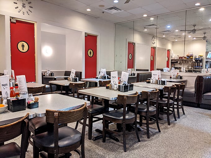 Red doors with porthole windows give this diner interior the feeling of stepping into a time capsule where calories don't count and conversations flow freely.