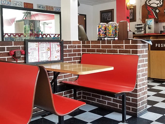 These classic red booths aren't just seating—they're time machines to when conversations flowed freely and smartphones were science fiction.