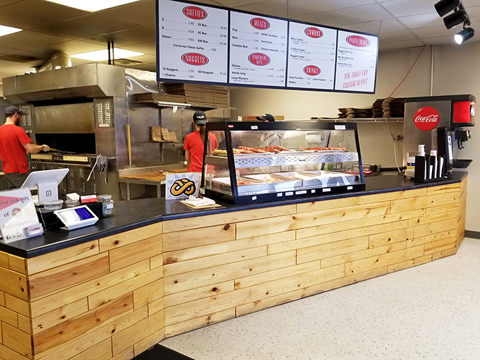 Behind this rustic wooden counter, pretzel magic happens daily. It's like watching artisans at work, if artisans specialized in perfectly twisted dough.