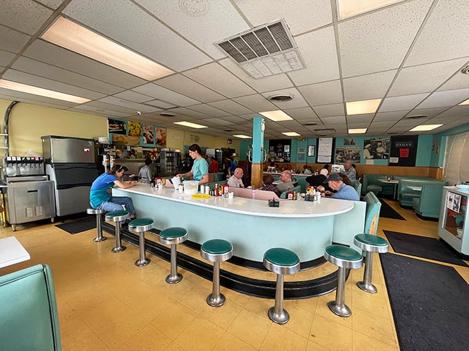 The mint-green counter with chrome stools isn't retro by design—it's authentic, having witnessed countless coffee refills and neighborhood conversations through the decades.