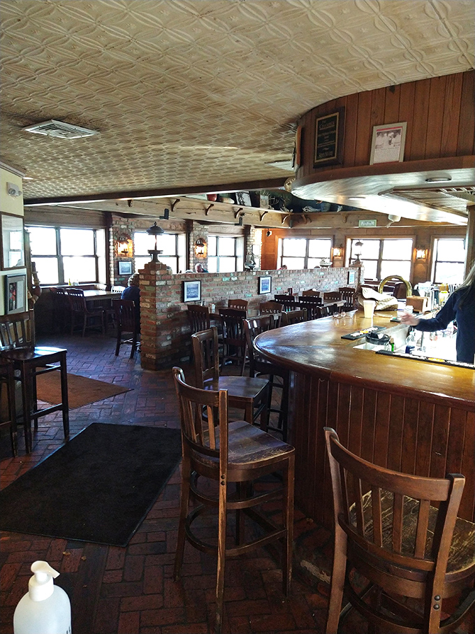 The interior feels like the living room of that cool uncle who retired to become a sea captain—warm wood, pressed tin ceiling, and stories in every corner.