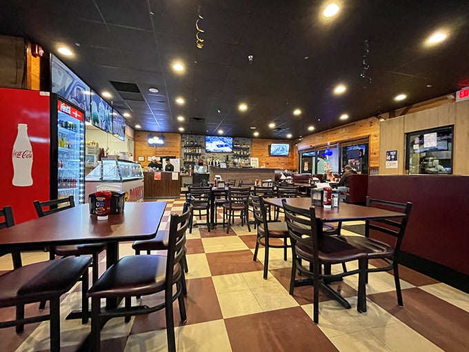 Simple furnishings, checkered floors, and wooden paneling create the perfect backdrop for culinary magic. Who needs fancy when the food does all the talking?