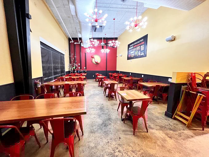 The vibrant interior features eye-catching red chairs and starburst light fixtures that say "wake up and enjoy life" before you've even had your coffee.