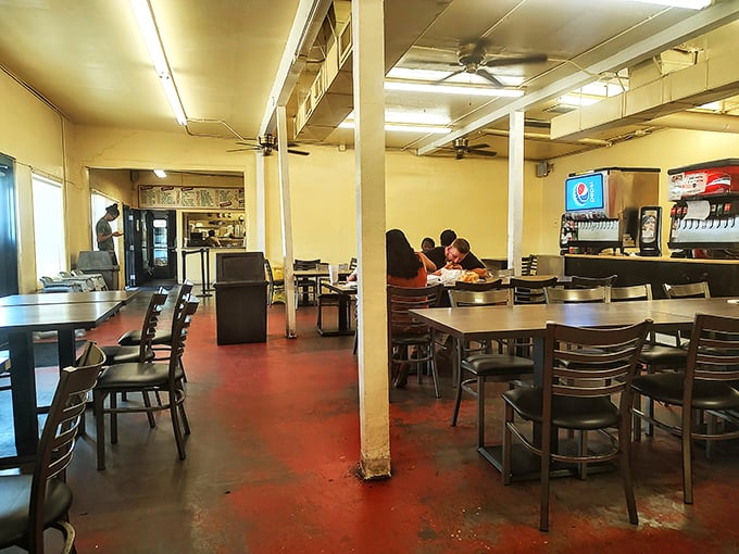 Simple tables, red concrete floors, and ceiling fans that have witnessed decades of happy diners. This isn't ambiance by design—it's authenticity by default.