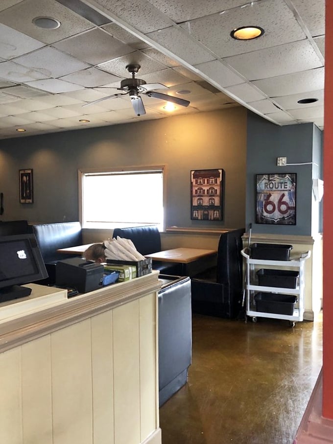 Blue booth seating and Route 66 memorabilia create that perfect throwback atmosphere where conversations flow as freely as the coffee.