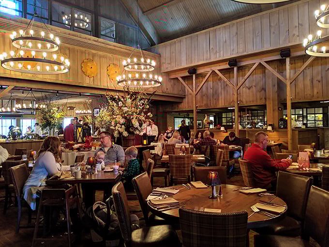 Soaring timber ceilings and ring chandeliers create a cathedral-like dining space where comfort meets sophistication—Midwest hospitality in architectural form.