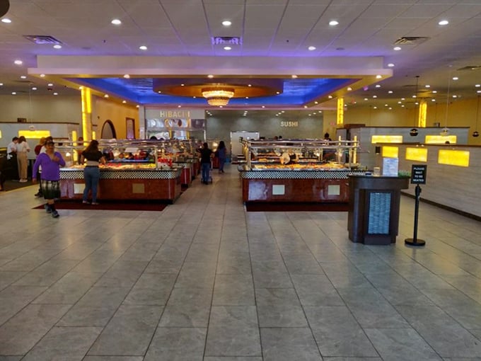 Step inside and the buffet wonderland unfolds—gleaming stations under blue accent lighting and a chandelier that adds a touch of unexpected elegance to your all-you-can-eat quest.