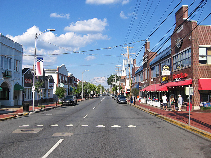 Blue skies frame Newark's inviting streetscape where local businesses thrive. The American flag waves proudly over a downtown that balances history with modern convenience.
