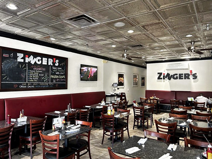 Classic tin ceilings, red booths, and wooden chairs create that perfect deli atmosphere—not too fancy, not too casual, just authentically right.