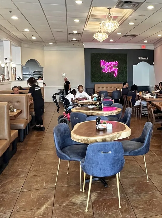 Elegant chandeliers meet cozy blue chairs in a space that feels like your stylish friend's dining room—if that friend were a breakfast savant.