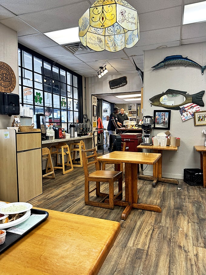 Wooden tables, fish décor, and a vintage lamp create the perfect backdrop for seafood magic. Simplicity with purpose.