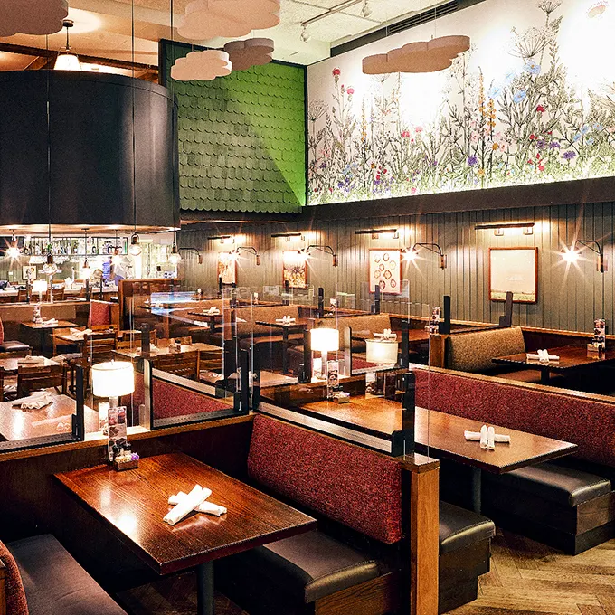 Farm-to-table never looked so stylish. The green scalloped wall and wildflower mural create an atmosphere that's equal parts rustic charm and urban sophistication.