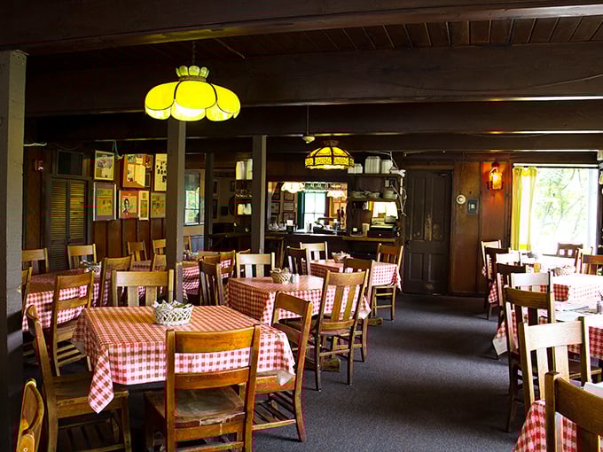 Classic red-checkered tablecloths and warm wood paneling create the kind of dining room where memories are made and diets are forgotten.