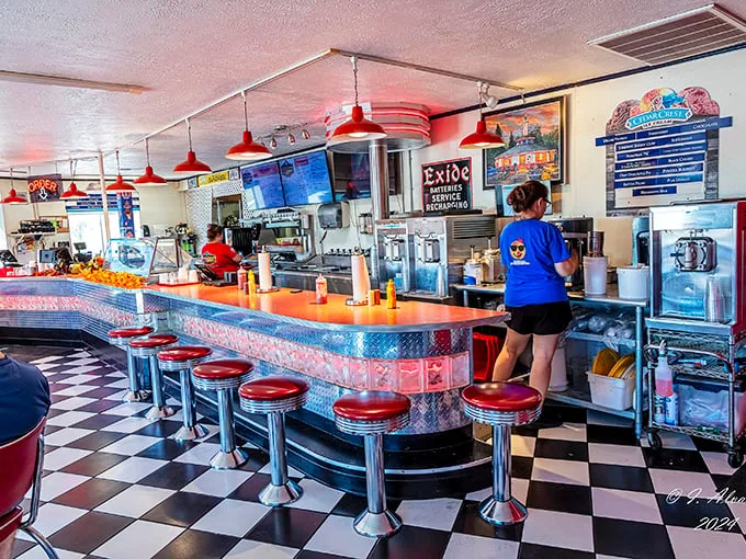 Classic Americana at its finest—chrome counters, red vinyl stools, and checkerboard floors create the perfect stage for burger magic to unfold.