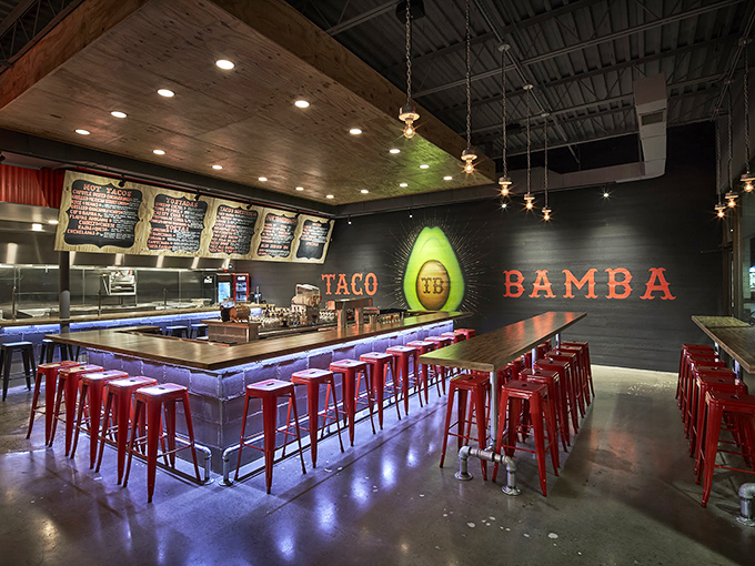 Industrial-chic meets taco temple. Those red stools aren't just seating—they're front-row tickets to the most exciting flavor show in Virginia.