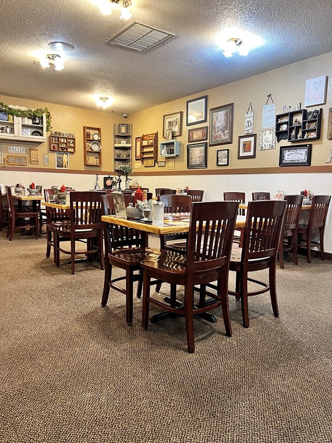 Wooden chairs, warm walls, and a gallery of memories – this dining room feels like the living room of that cool aunt who always fed you too well.