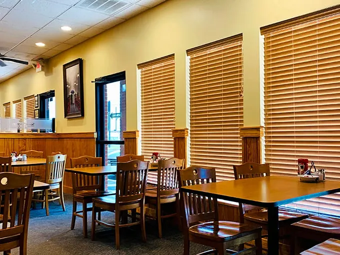 Wooden blinds filter morning light across comfortable seating, creating that perfect "I could linger here all day" ambiance that every great breakfast spot needs.