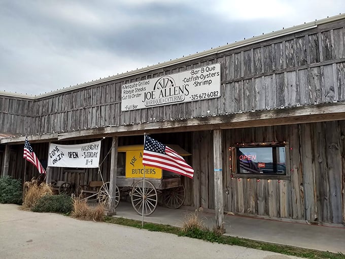 American flags flying proudly outside this weathered wooden treasure – patriotism and great steaks under one roof.