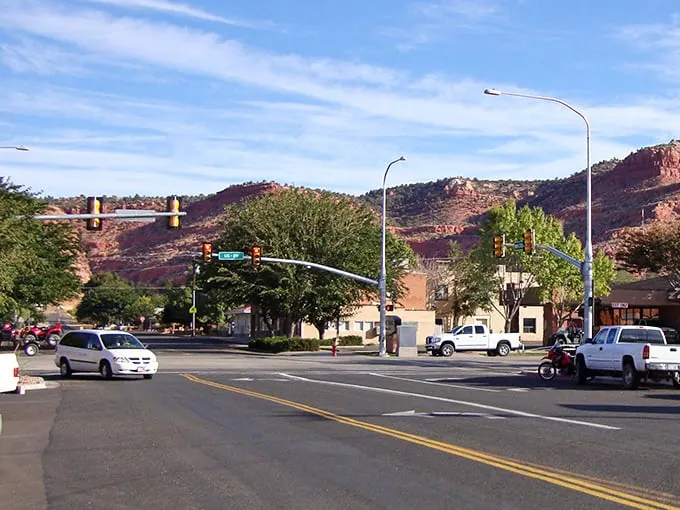 Those aren't painted backdrops—Kanab's stunning red rock formations are the real deal, framing this charming desert town.