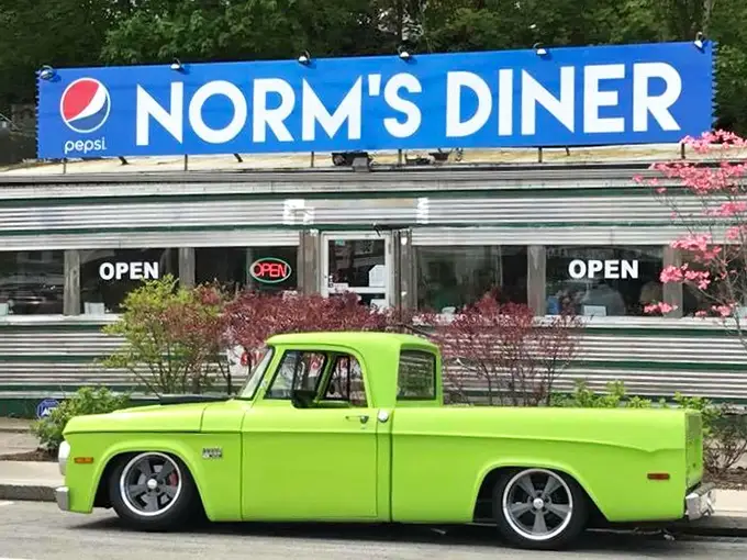 Norm's Diner with green truck: "Classic chrome meets lime-green vintage truck—a time-travel tableau that promises the kind of breakfast your grandparents raved about."