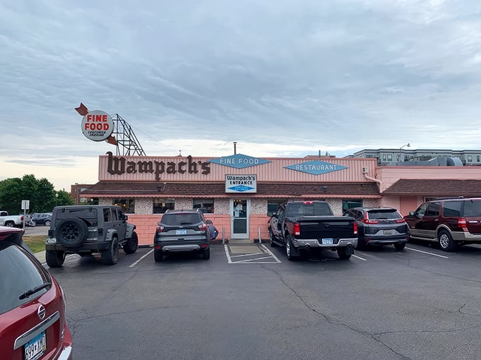 Wampach's Restaurant: That retro pink exterior isn't just a building—it's a time machine disguised as a restaurant with a "Fine Food" sign that doesn't lie.