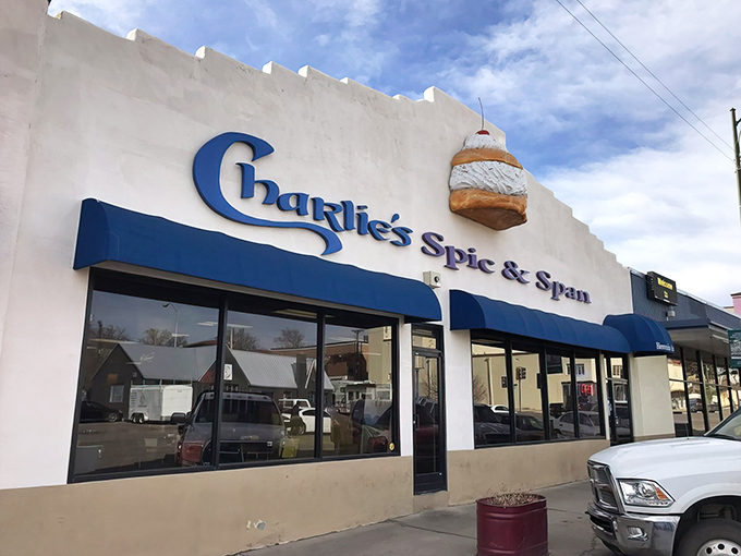 The blue awnings of Charlie's are like a beacon for breakfast lovers. That cinnamon roll sign isn't just decoration – it's a promise!