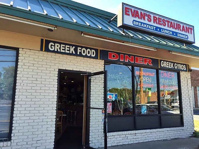 The bold "Greek Food" sign isn't just decoration—it's a promise that Evan's delivers on with every bite of their authentic Mediterranean dishes.