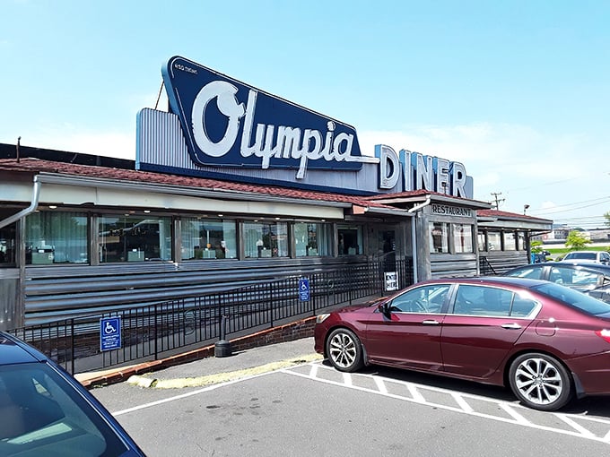 Sunset casts a magical glow on Olympia Diner's classic profile – where chrome dreams and comfort food meet.