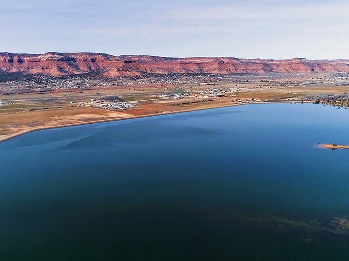 Nature's perfect panorama: Kanab nestled between azure waters and crimson cliffs, like a watercolor painting come to life.