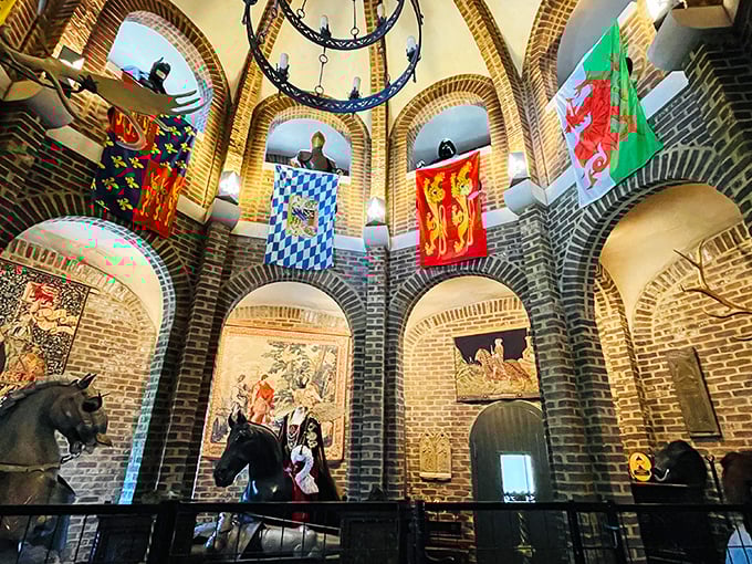Inside, the great hall dazzles with exposed brick arches, colorful heraldic banners, and medieval décor that transports visitors across centuries and continents.