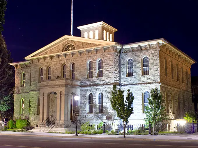 The Nevada State Museum illuminates after dark, its sandstone walls telling stories of silver booms and frontier dreams.