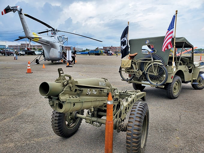 Military history buffs, rejoice! Vintage equipment and a helicopter create an impromptu time capsule in the parking lot, like a yard sale for history enthusiasts.