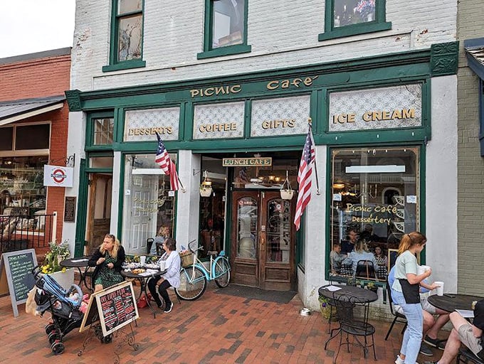 The Picnic Cafe's inviting storefront promises desserts, coffee, and ice cream—the holy trinity of small-town delights that no diet plan can resist.