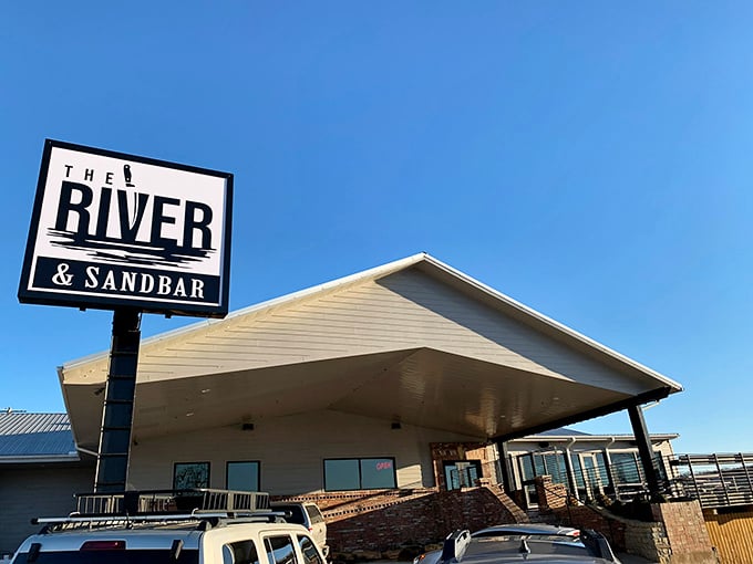 The River & Sandbar isn't just a restaurant—it's where locals gather to watch the sunset paint the White River while savoring Southern classics with modern flair.