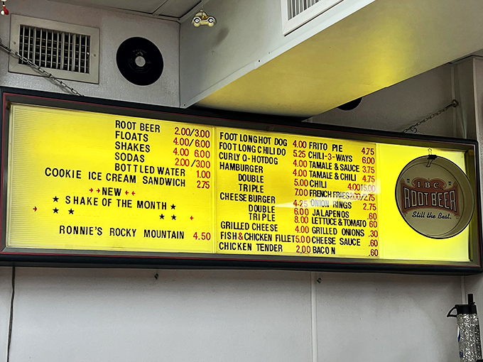The yellowed menu board tells you everything you need to know about Carl's priorities: burgers, root beer, and absolutely zero pretension.