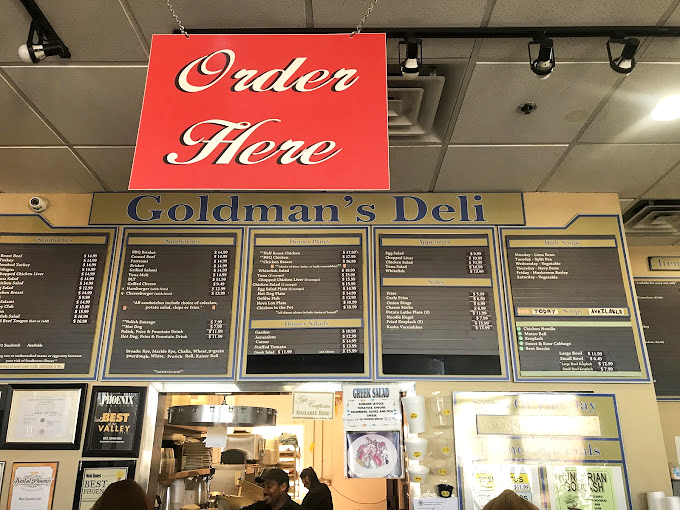 The menu board reads like a love letter to traditional deli fare. Decision paralysis has never been so delicious!