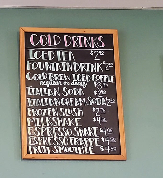 The handwritten drink menu board – where decisions are made, budgets are contemplated, and caffeine dreams come true.